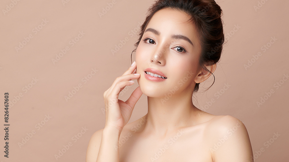 Beautiful young asian woman with clean fresh skin on beige background ...