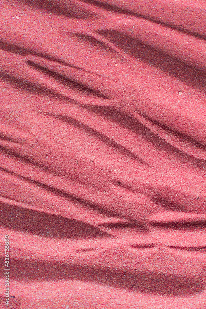 Lines drawn in pink sand background, beautiful sand texture, overhead ...