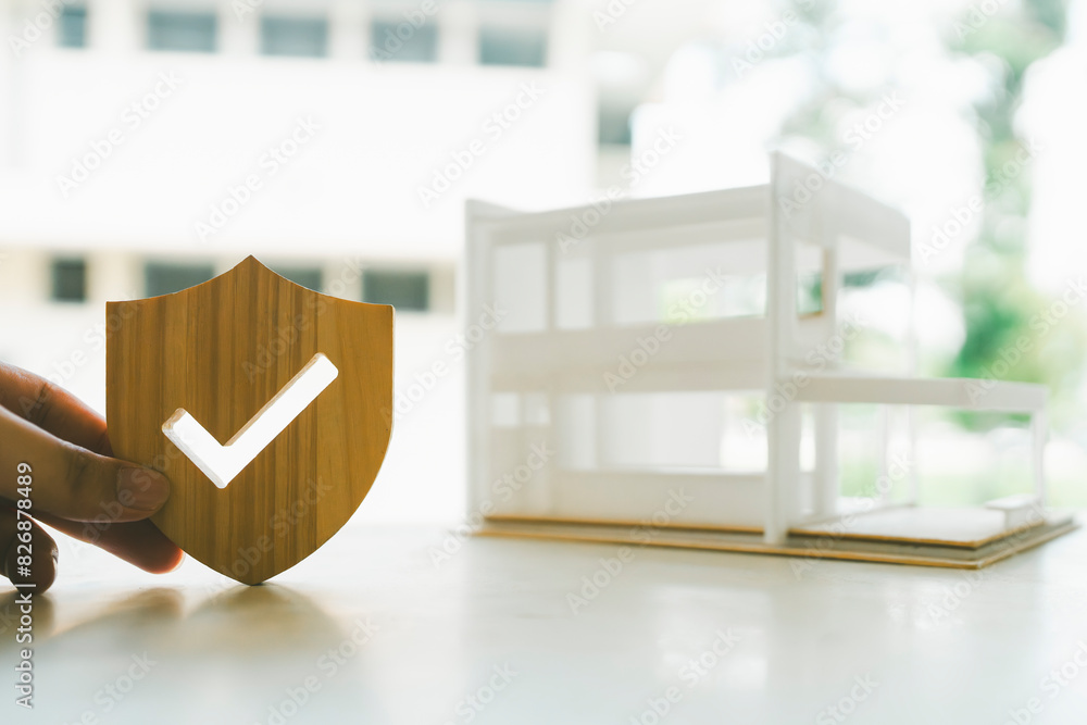 Wooden house model and real estate insurance ideas, and small shield ...