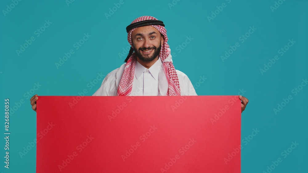 Muslim person holding empty banner to create commercial advertisement ...