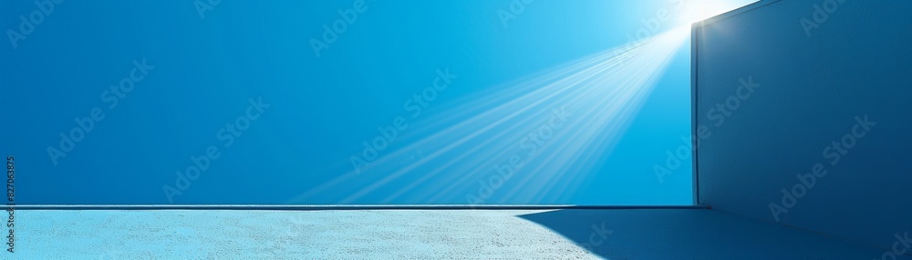 Minimalistic blue wall and floor under sunlight with diagonal sun rays ...