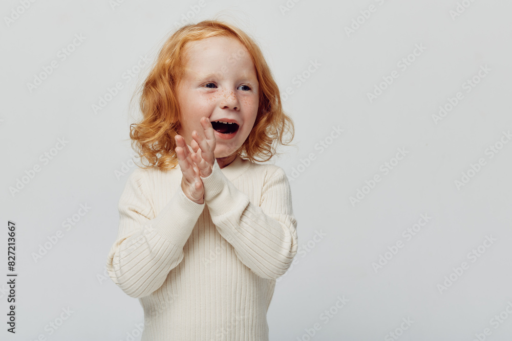 Happy little girl clapping hands in joyful expression against white ...