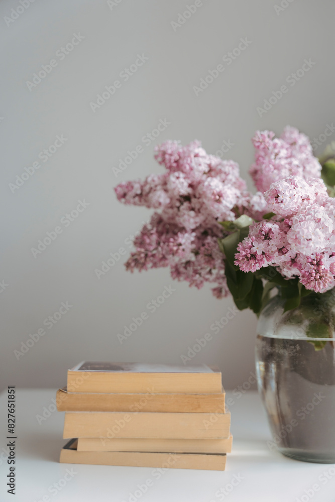 Stack of old books with lilacs in vase, cottagecore aesthetic ...