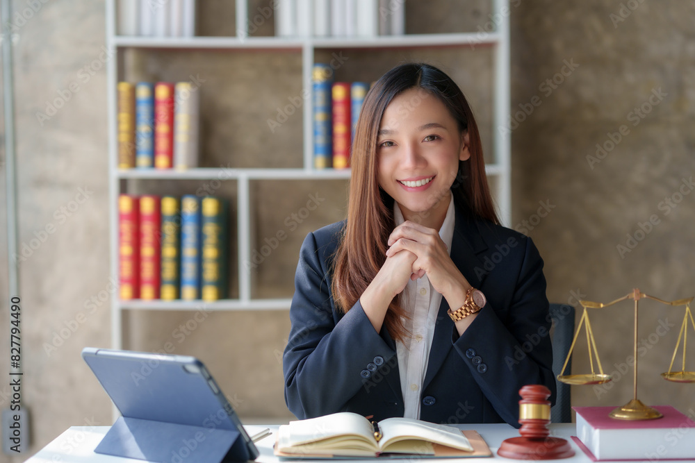 Businesswoman is in a legal office with a gavel and scales of justice ...