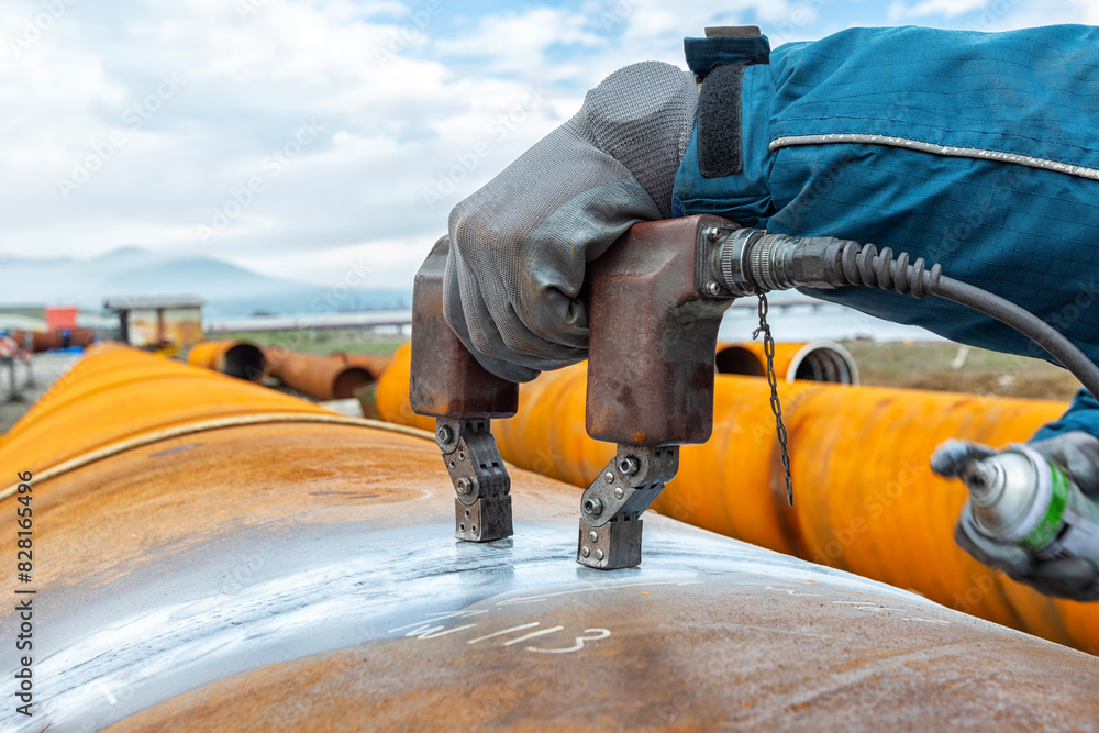 Magnetic particle inspection (MPI) of pipe weld. It is a nondestructive ...