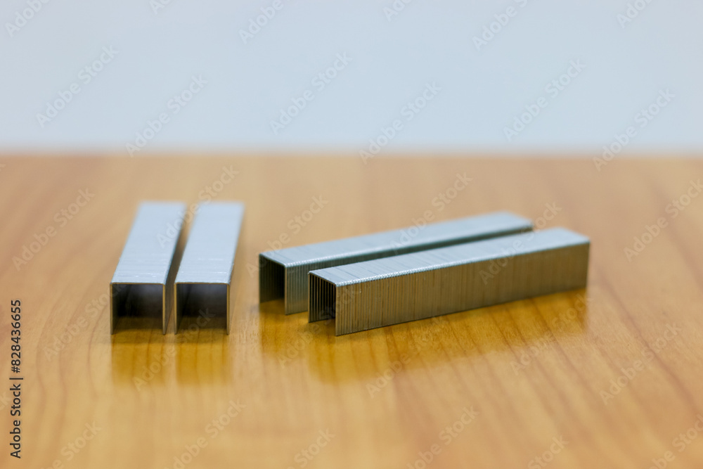 Metal staples on the table for a stapler that was used in office or ...