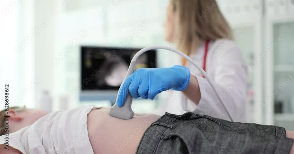 Ultrasound examination of child doctor makes scan of the abdomen of ...