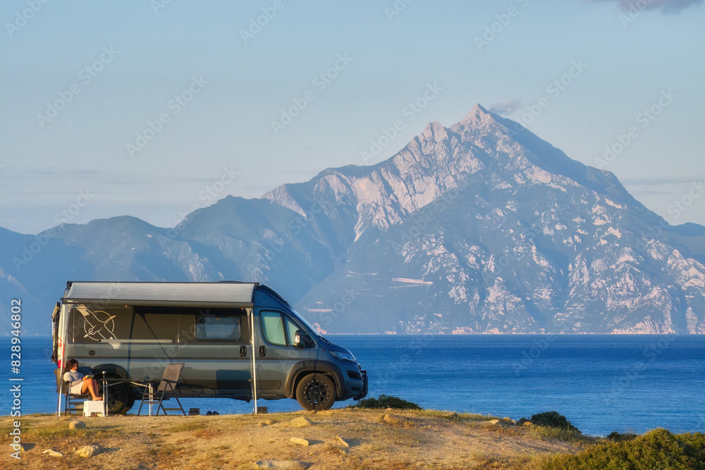 Camper van parked by the sea with a stunning view of Mount Athos in the ...