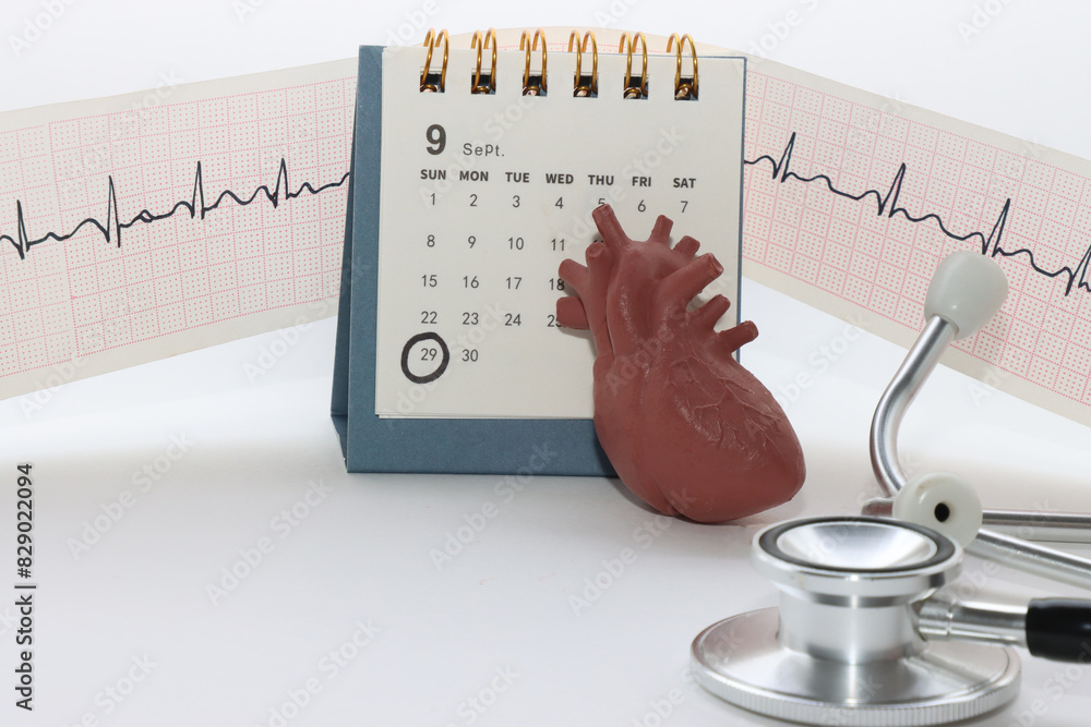 Calendar with the world heart day marked, a 3d heart, a stethoscope and ...