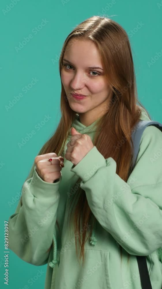 Vertical video Woman doing fighting stance, pretending to do boxing ...