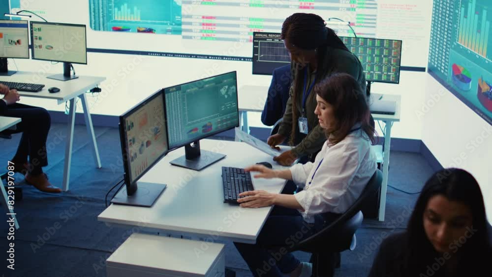 Business associates comparing key performance indicators within the ...