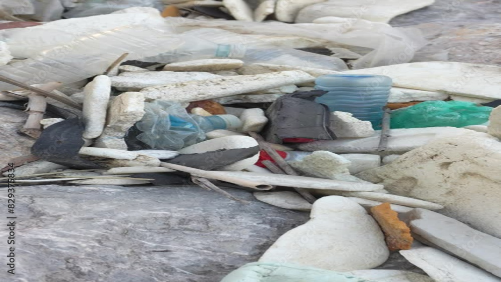 A pile of trash with a white object in the middle. The trash is made up ...