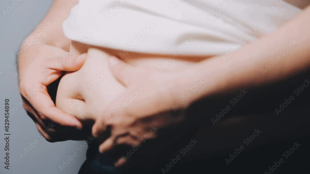 Man pointing own unhealthy big belly with visceral or subcutaneous fats ...