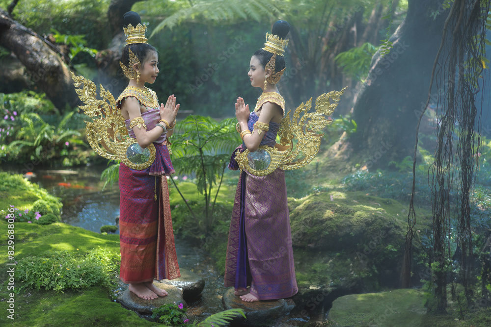 Beautiful girl in a Kinnari dress in green natural with the moss and ...