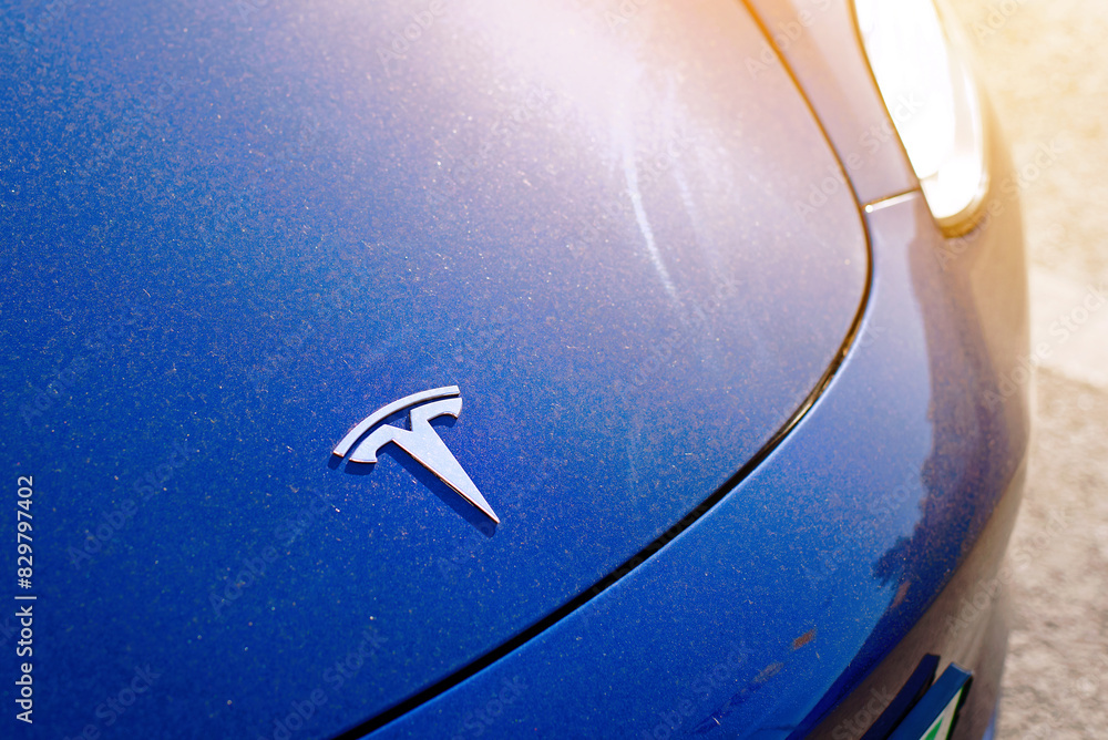 Minsk, Belarus. May 1, 2024. Tesla logo on dusty blue hood. Tesla shiny ...