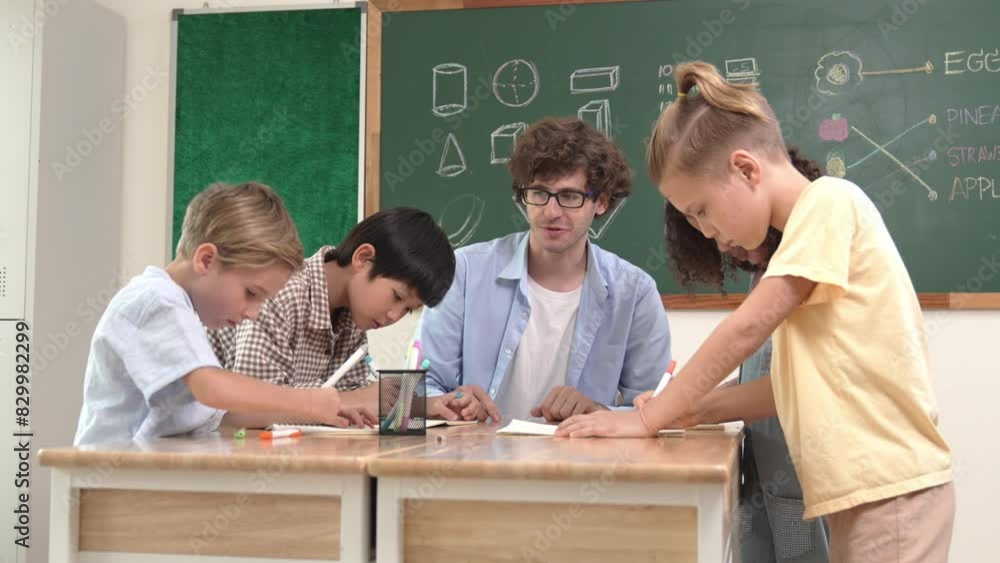 Smart teacher explain idea while diverse children drawing mind map ...