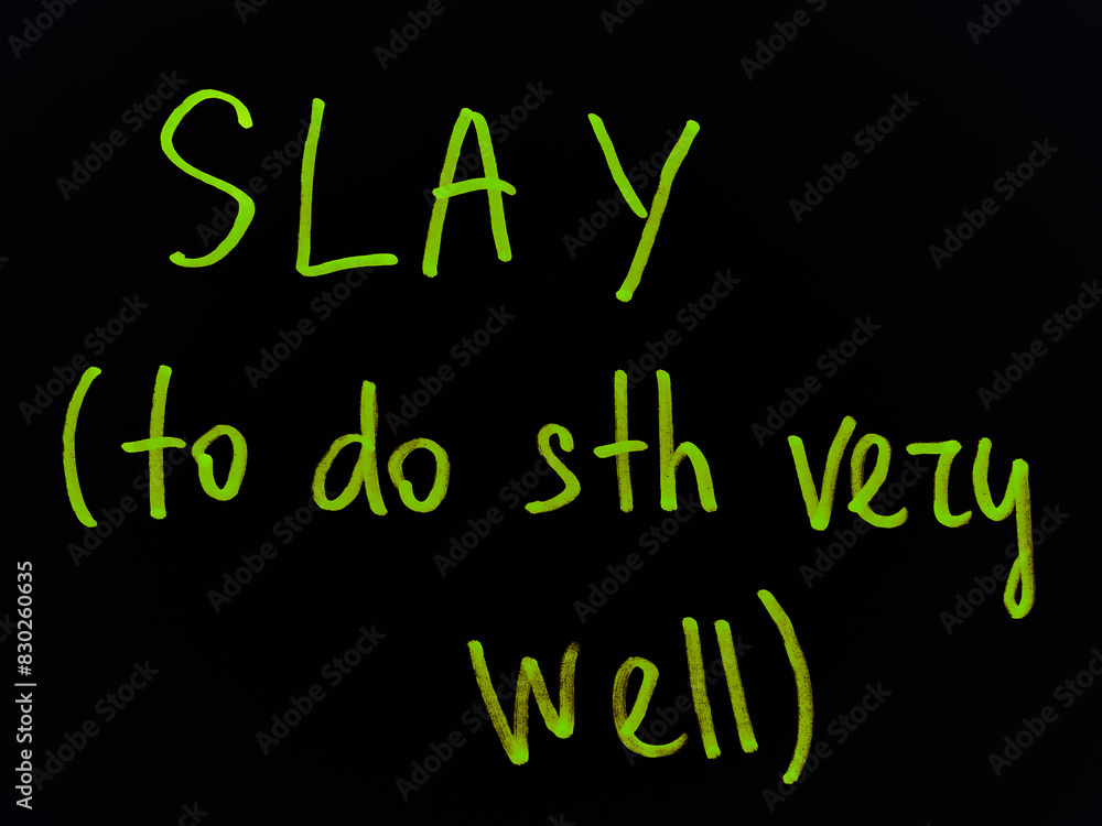 Word "slay", written on a sheet of black paper, various words and ...