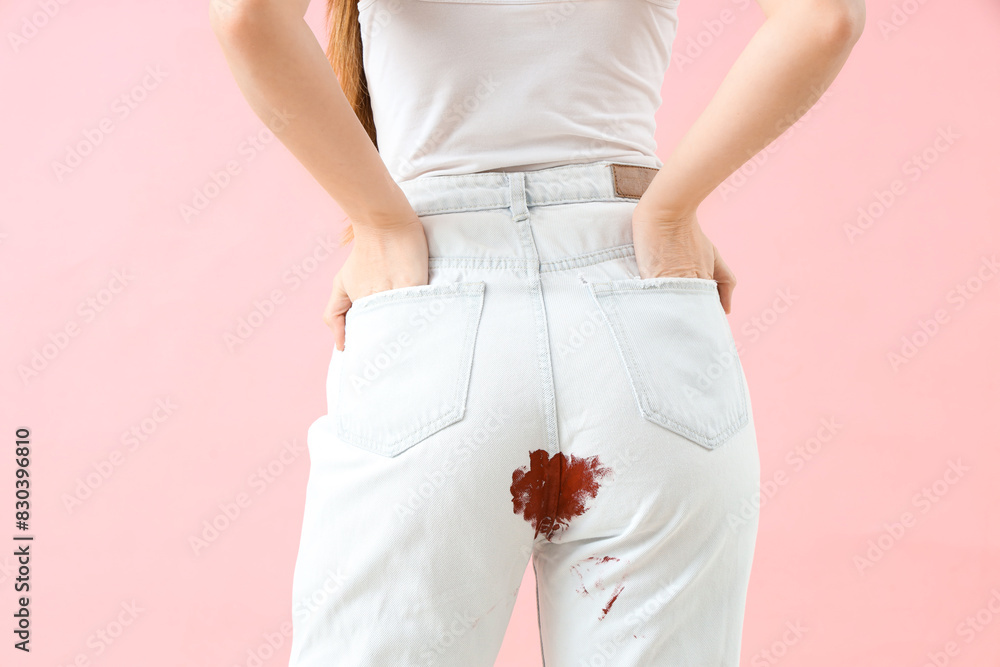 Menstruating woman in stained pants on pink background, back view. Free ...