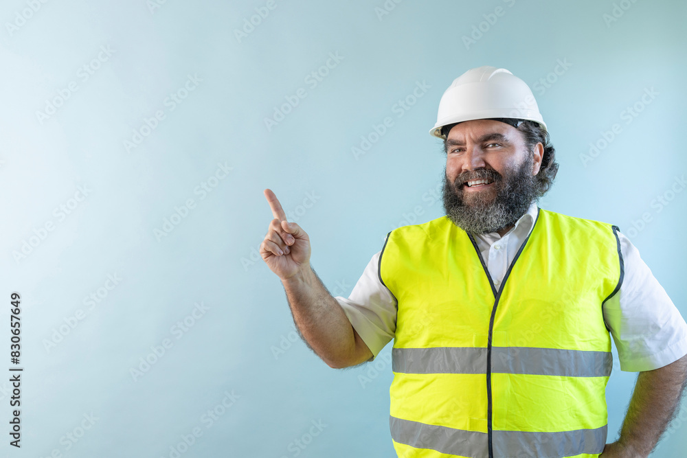 smiling adult man engineer with beard and wearing helmet and safety ...