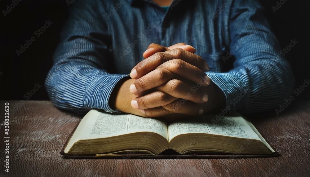 Man praying with the Bible - Reading the Holy Book of Christianity ...