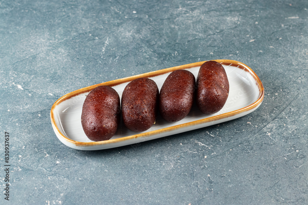 Gulab Jamun, kalo jam or mohan served in tray dish isolated on grey ...