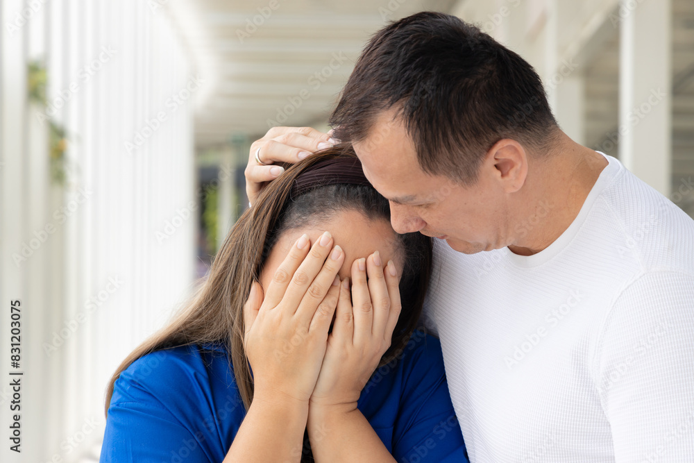 Attentive Middle aged husband taking care of his sad crying wife ...