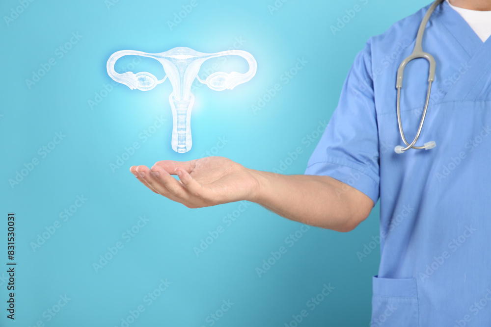 Doctor and illustration of female reproductive system on light blue ...