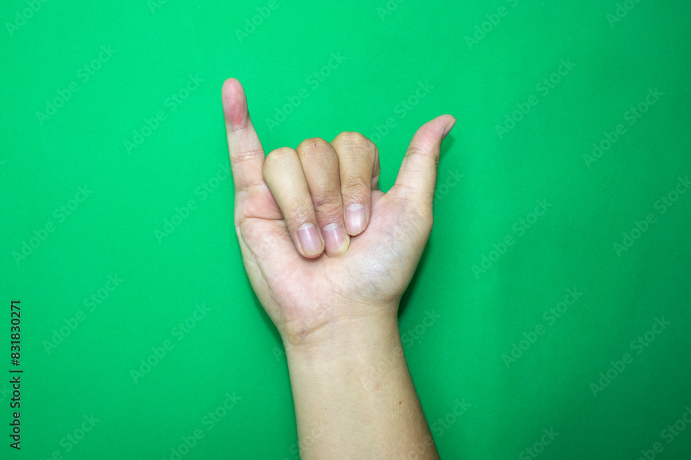 hand showing sign, sign language of alphabet of Y, on green background ...
