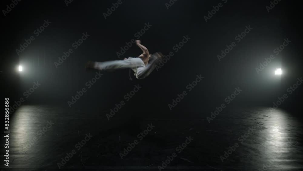 Capoeira fighters performing dynamic moves on stage. Martial arts ...