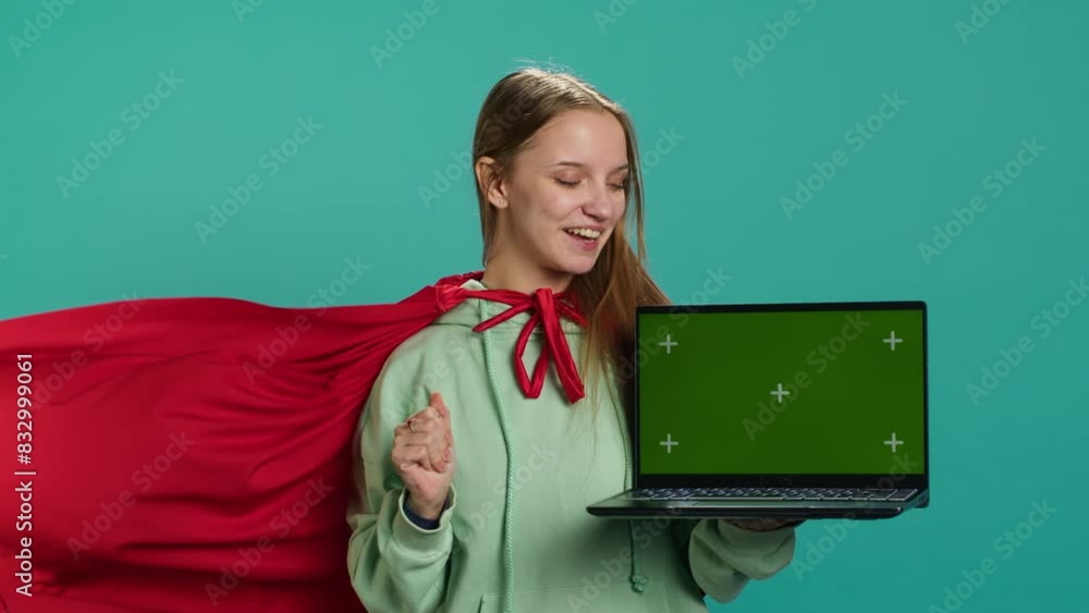 Young girl wearing superhero costume presenting and talking about green ...