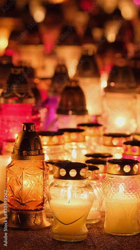 Candle lights on graves and tombstones in cemetery at night in Poland during All Saints Day ...