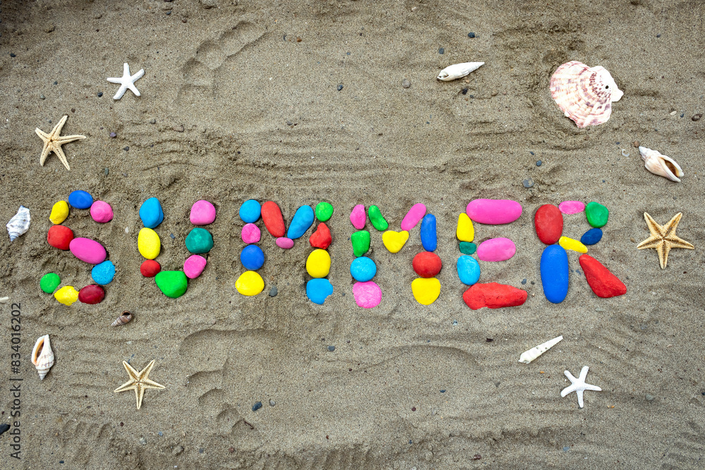 Multi colored word Summer made of painted pebbles on beach sand Stock ...