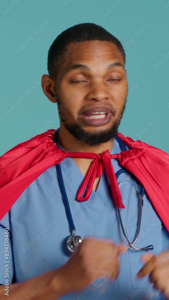 Vertical video Male nurse portraying superhero showing courage and ...