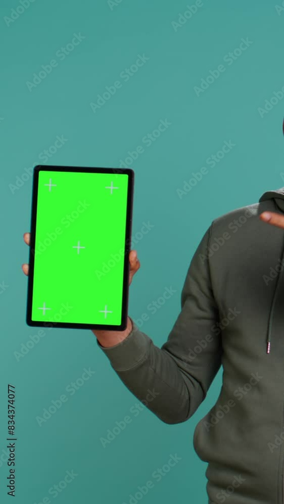 Vertical video Joyous african american man holding isolated screen ...