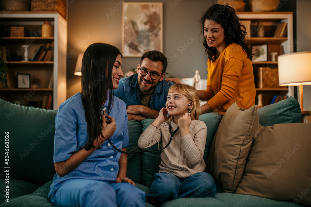 Doctor listening little girls lungs during routine medical examination ...