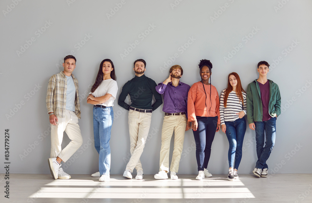 Seven confident people of different ethnicities are standing facing ...
