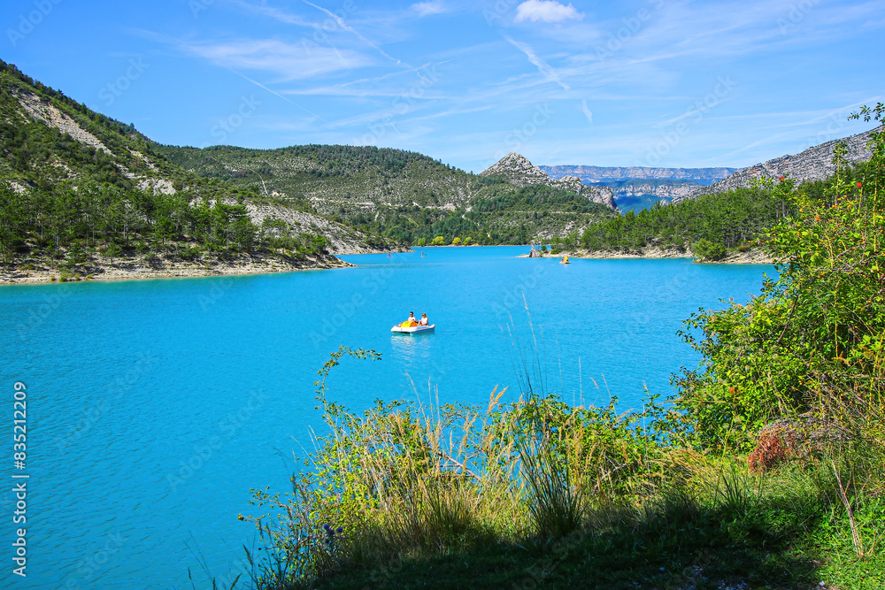 Pedal boat on the turquoise waters of the Lake of Castillon in the ...