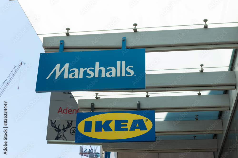 exterior signs installed beneath canopy over sidewalk at Aura Concourse ...