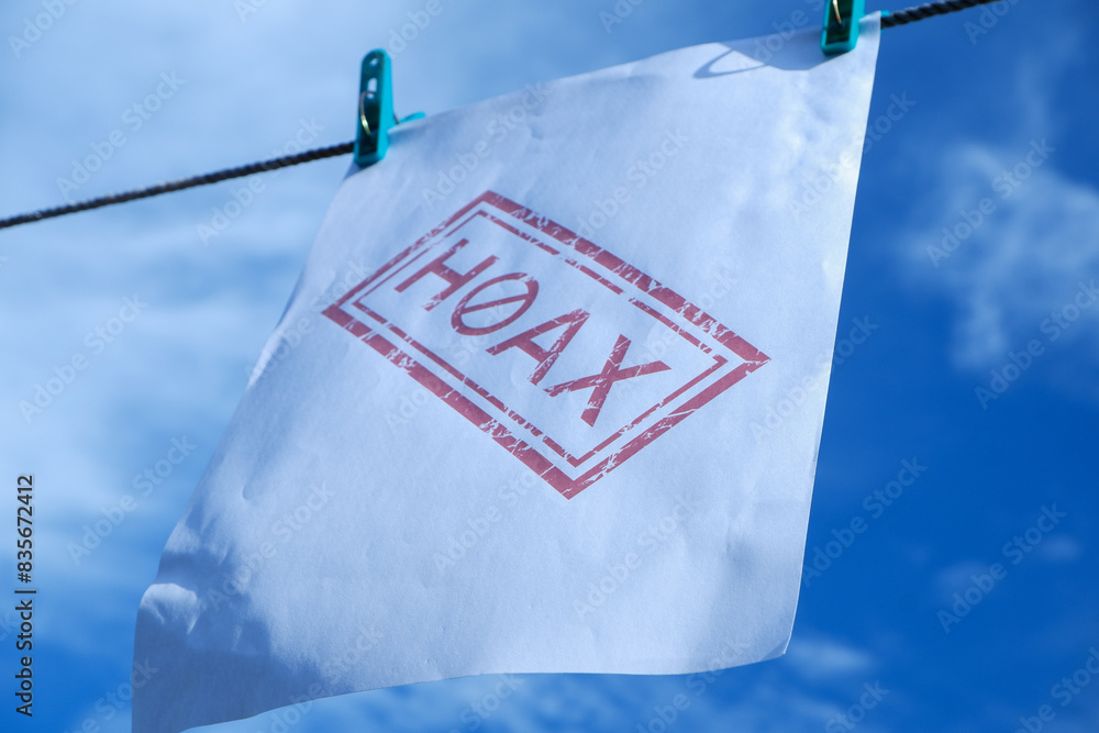 white paper hanging with red hoax writing. illustration concept of stop ...