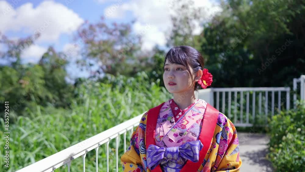 A young woman in her twenties, wearing traditional Ryusou, is walking ...