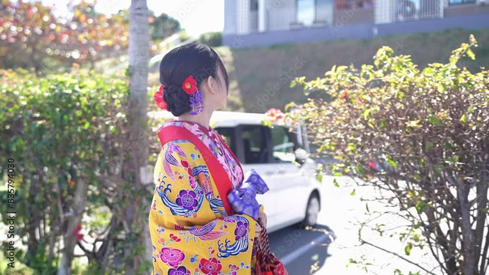A young woman in her twenties, wearing traditional Ryusou, is walking ...