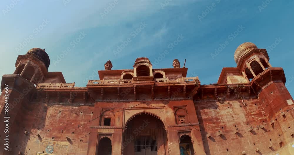 Varanasi, Uttar Pradesh, India. Doves take off from old red wall Chet ...