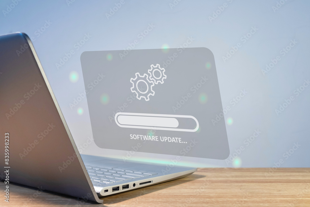 Software system update process concept. A laptop on the table with ...