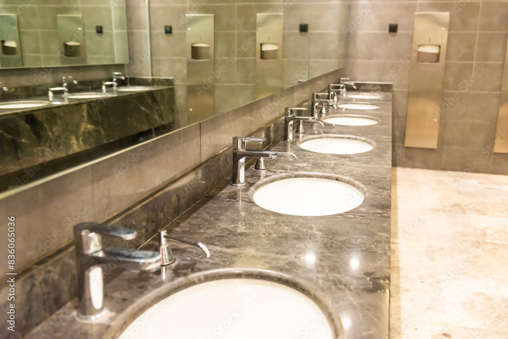 Public bathroom restroom lavatory interior with row of white ceramic ...