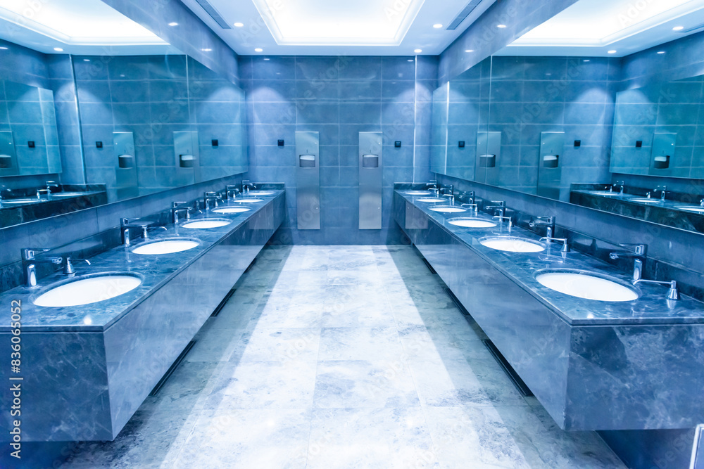 Public bathroom restroom lavatory interior with row of white ceramic ...