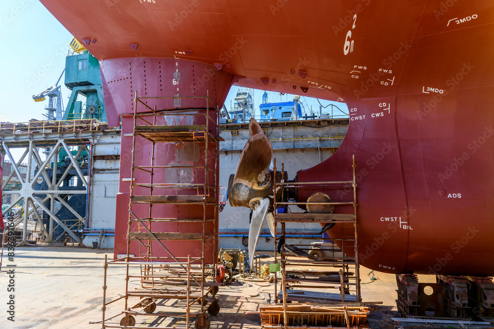 Cargo vessel in dry dock on ship repairing yard. Variable pitch ...