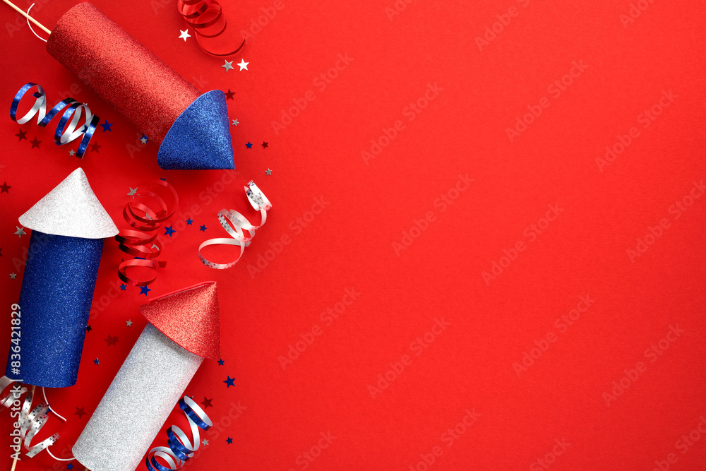 Firework rockets on red background with confetti, flat lay. Happy ...