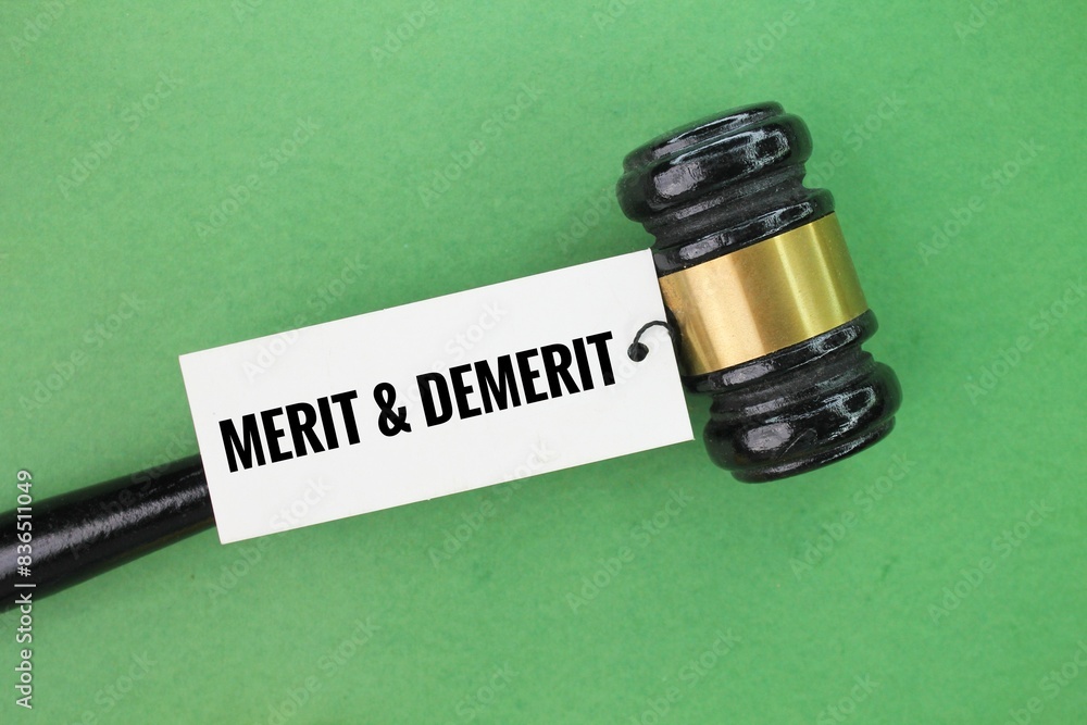 judge's gavel and white paper with the words Merit and Demerit. fine ...