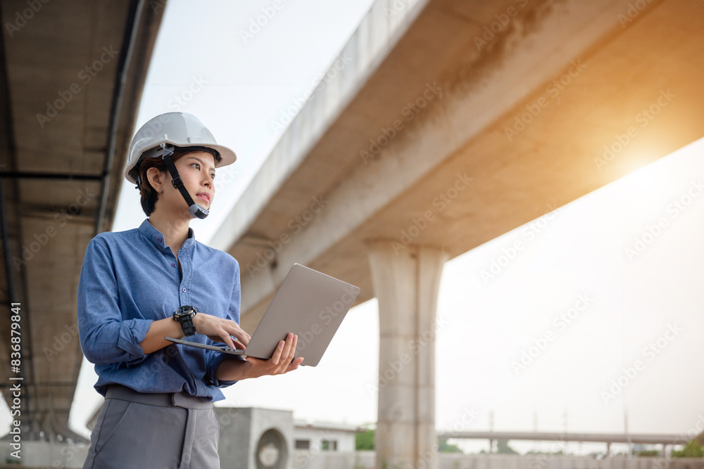 An Asian woman architect working at a highway construction site Female ...