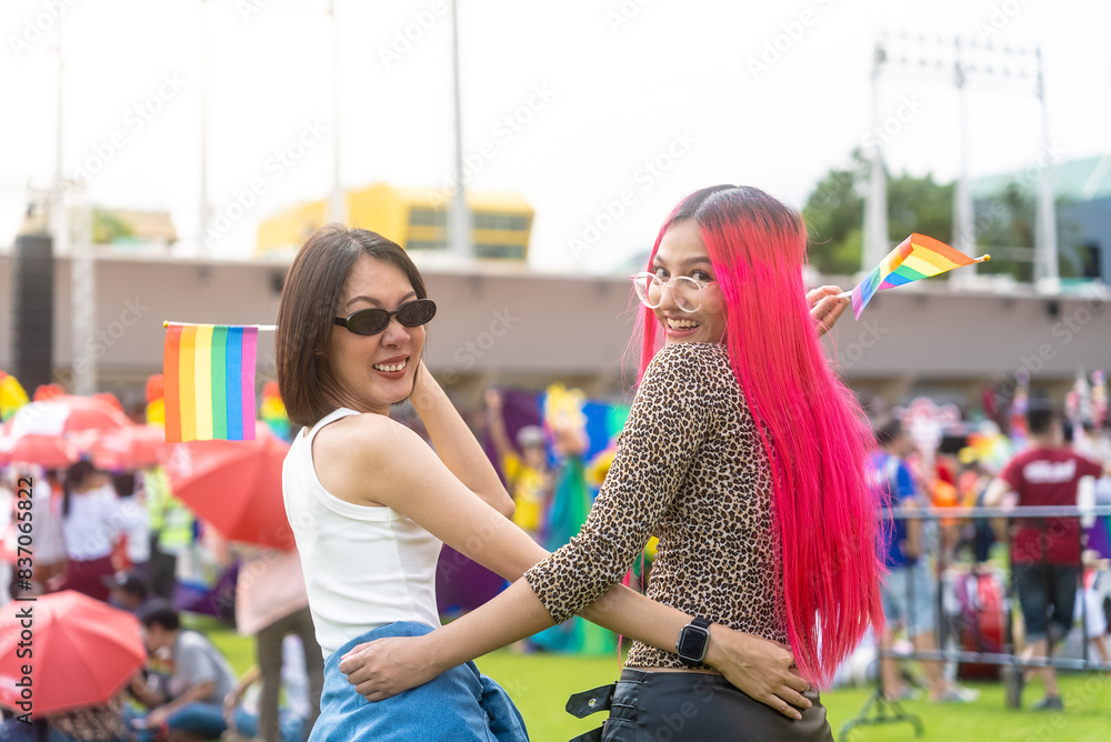 Happy young asian lesbian couple with pride movement LGBT holding ...